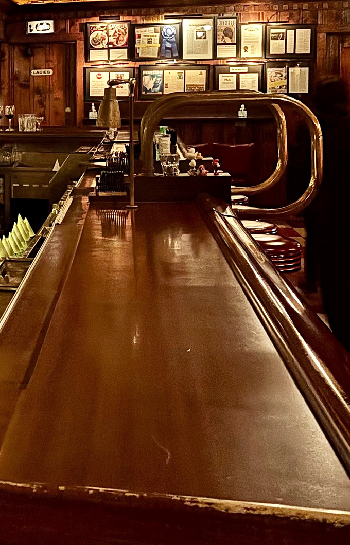The bar counter gleams with decades of polish and promise &ndash; a front-row seat to steakhouse theater at its finest.