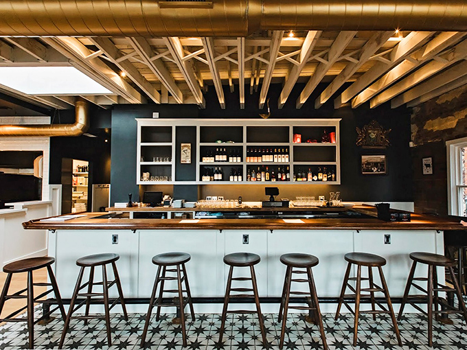 The bar offers front-row seats to pizza perfection, where watching the craft behind your meal adds an extra layer to the experience.