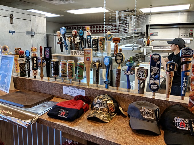 Where beer flows from taps labeled with the promise of refreshment, while Pizza Barn merchandise tempts you to become a walking billboard.