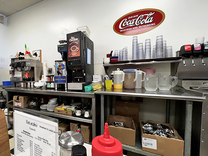 The beverage station—where coffee flows like conversation and the Coca-Cola sign reminds us some traditions never need updating.
