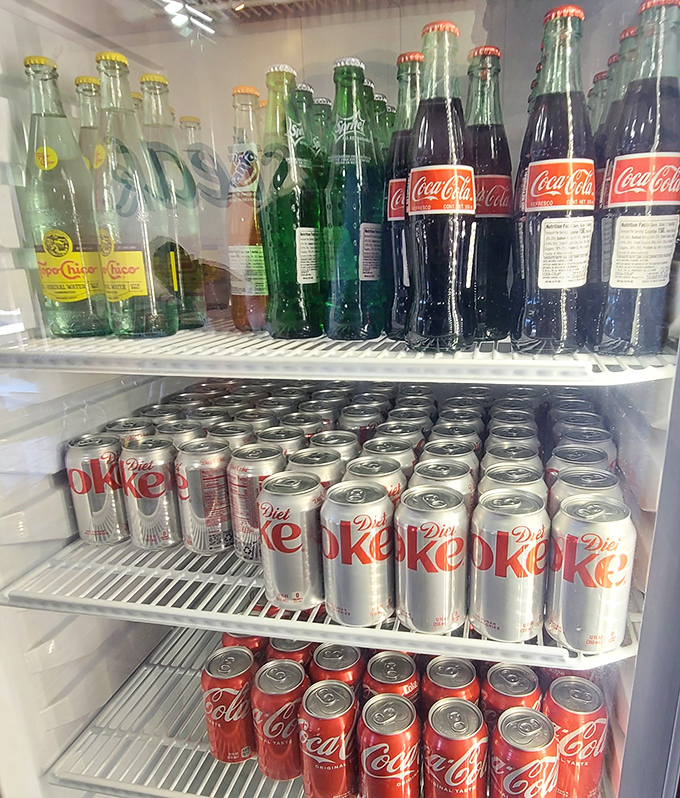 The beverage shrine &ndash; a colorful array of liquid companions waiting to join your cheesesteak adventure. Classic glass bottles add that nostalgic touch we didn't know we needed.