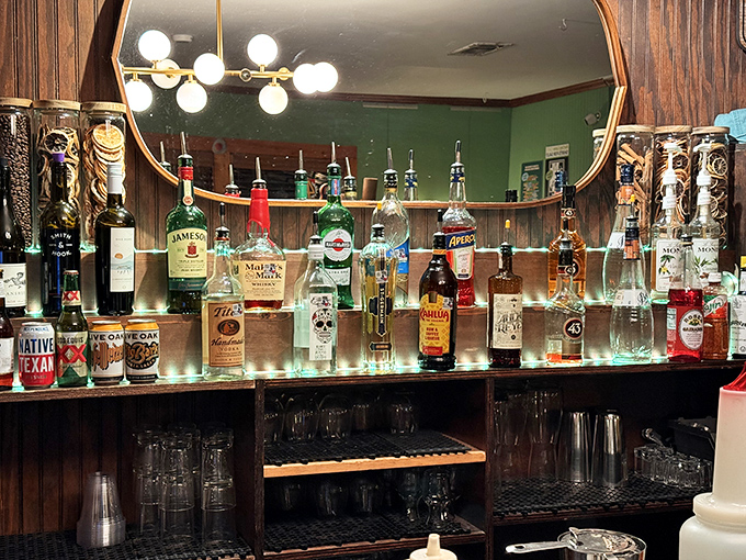 The bar display showcases Texas spirits alongside global favorites &ndash; liquid companions for your pancake journey.