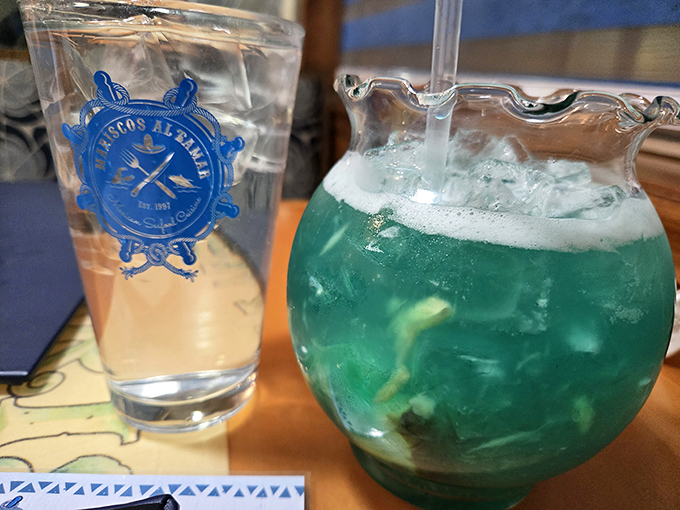The restaurant's branded glassware holds the promise of refreshment, while that blue concoction looks like someone bottled the Caribbean Sea.