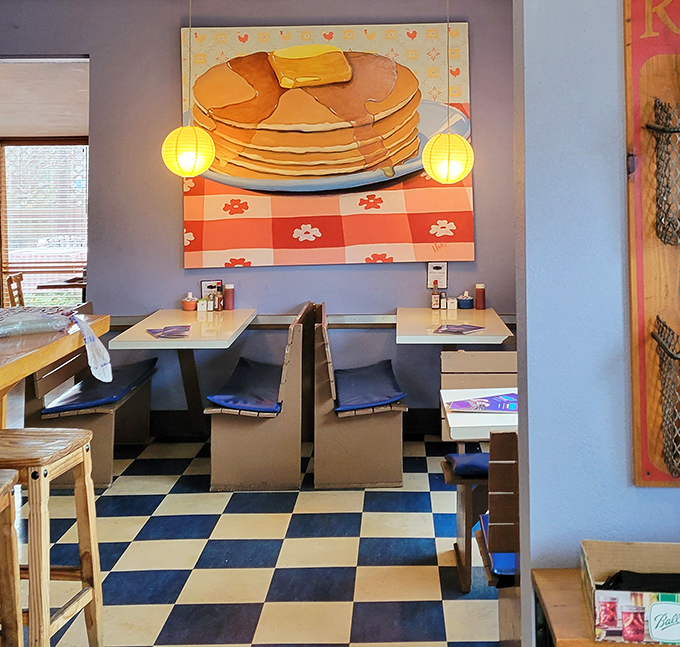 Whimsical pancake art watches over diners in this checkered-floor nook that feels like it was designed specifically for leisurely breakfast conversations.
