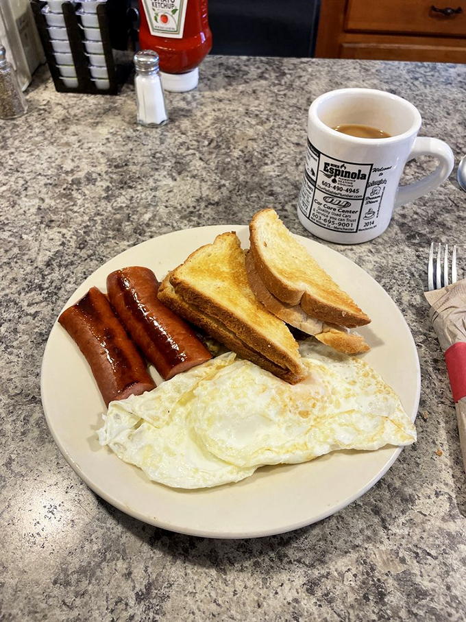 The breakfast trinity—eggs, sausage, and toast—executed with the kind of precision that makes morning people out of night owls.