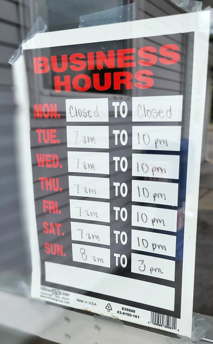 Business hours posted with the confidence of a place that knows you'll rearrange your schedule just to make it there for Tuesday breakfast.