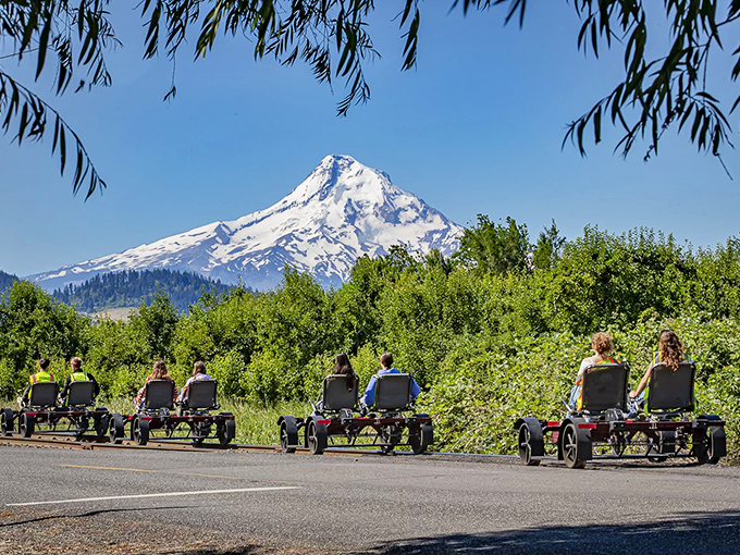 Mount Hood plays peekaboo through the trees while visitors enjoy the foreground view from what might be the world's most scenic pedal carts.