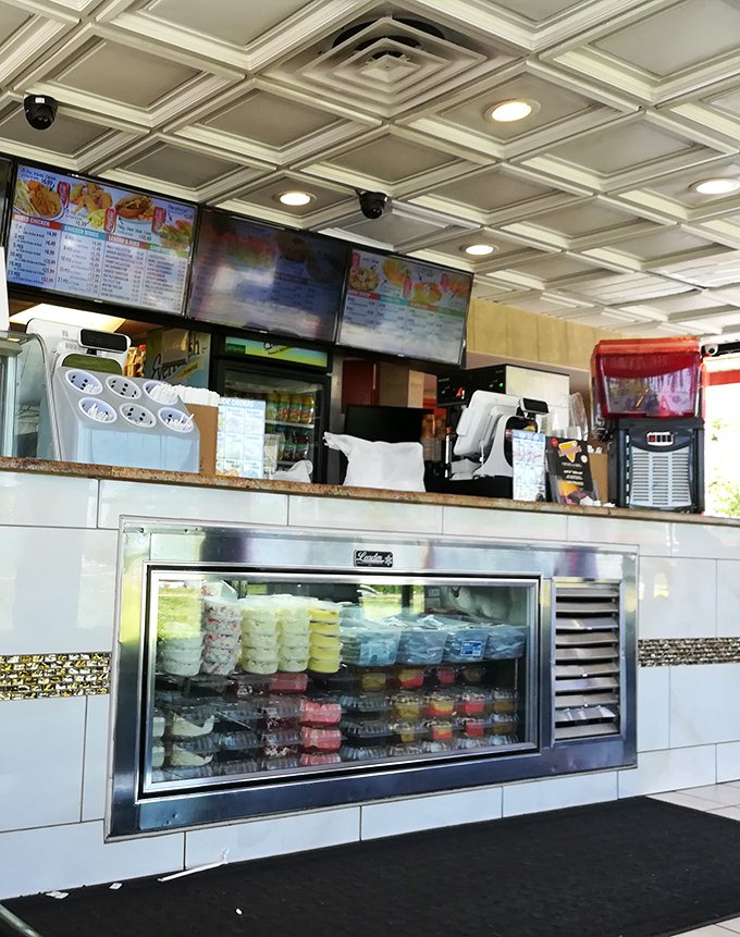 Behind the counter is where the magic happens&mdash;digital menus above and a display case below showcasing sweet endings to savory meals.