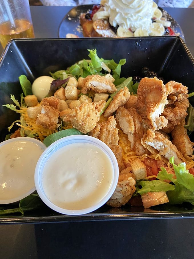 A chicken salad that proves healthy eating doesn't mean punishment. Fresh greens, crispy chicken, and those dipping sauces are calling your name.