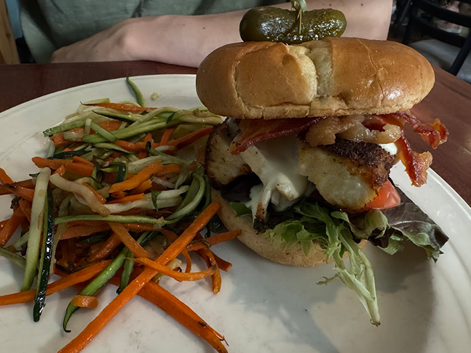 This isn't just a sandwich—it's architecture with attitude, where crispy chicken, bacon, and fresh vegetables create the perfect handheld masterpiece.