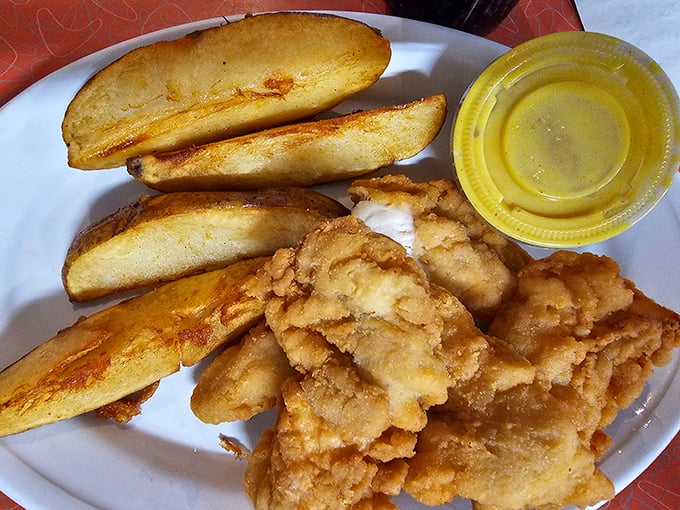 Chicken tenders with the golden-brown crispiness that fast food chains try (and fail) to replicate, alongside potato wedges that put regular fries to shame.