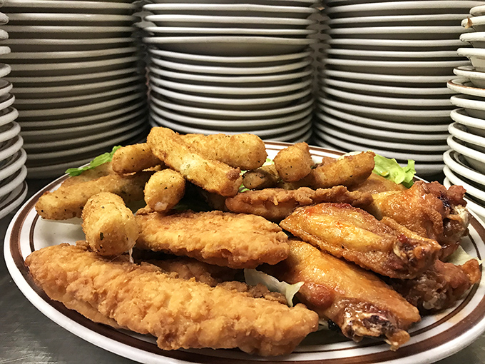 Fried chicken and hush puppies arranged with the kind of care usually reserved for diamond displays at Tiffany's. Crispy, golden, and worth every napkin. 
