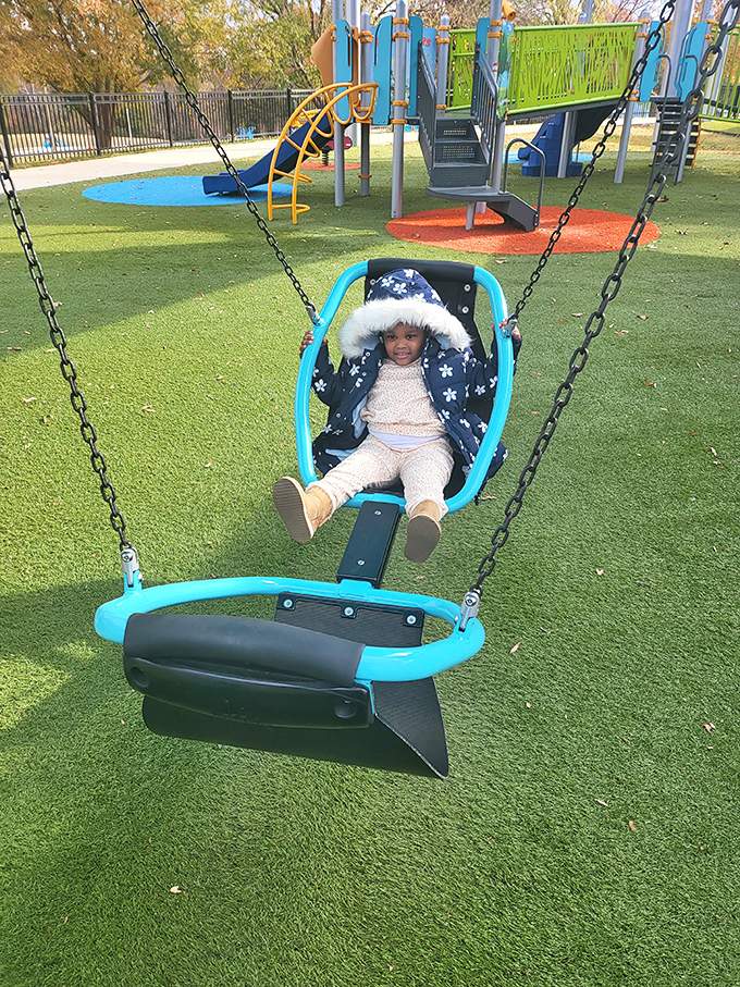 Childhood joy captured mid-swing, where the only notification that matters is the call of "Higher, higher!" against a backdrop of play structures.