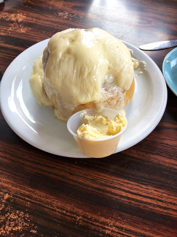 This cinnamon roll isn't just big&mdash;it's approaching planetary status. That butter on the side isn't a condiment; it's a commitment to living your best life.