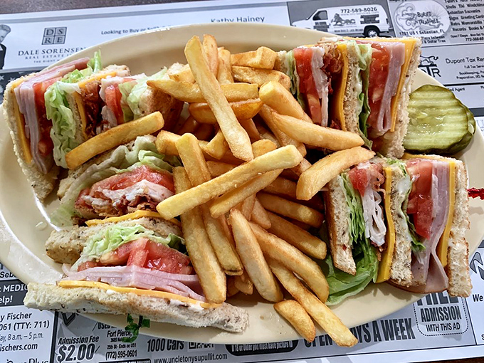 The club sandwich – architectural marvel of the diner world, triple-decker magnificence surrounded by a golden moat of perfectly cooked fries.