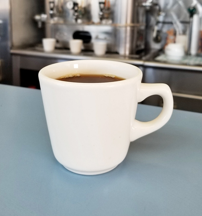 No fancy latte art or pretentious pour-overs here. Just honest coffee in a sturdy white mug that promises to jump-start your day without judgment.