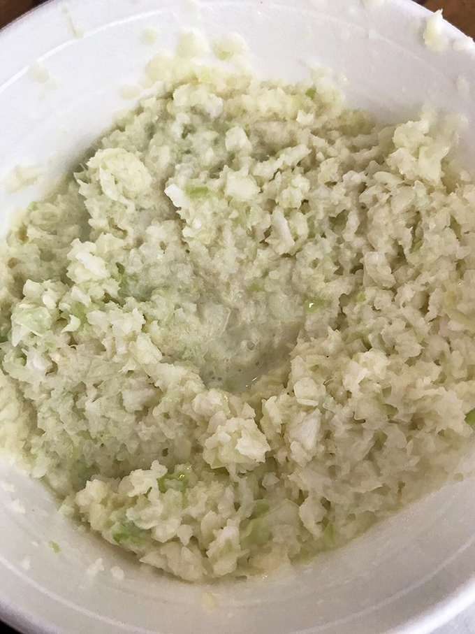 Coleslaw so finely chopped it's almost ethereal—the cool, tangy counterpoint that cuts through rich pork like a well-timed punchline.