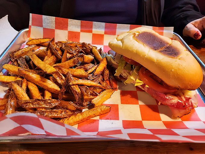 A sandwich and fries served on checkered paper &ndash; the universal signal that you're about to experience something authentically delicious without pretension.