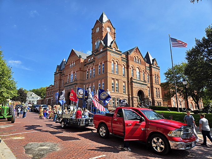 The magnificent Cass County Courthouse presides over a parade, its clock tower keeping time for community traditions that bind generations together.