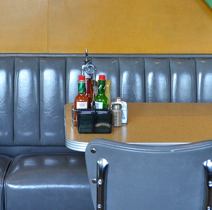 That condiment caddy is the unsung hero of any great deli experience&mdash;hot sauce, ketchup, and mustard standing at attention, ready for duty.