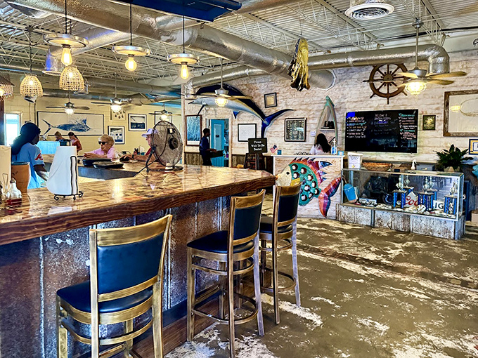 The bar area channels Old Florida with weathered wood, maritime artifacts, and the promise of cold drinks with unbeatable water views.