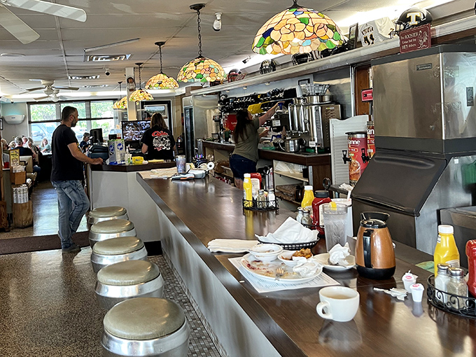 The counter area showcases beautiful stained glass pendant lights &ndash; unexpected touches of elegance in this unpretentious eatery.