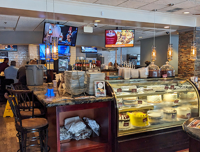 The dessert case&mdash;where good intentions go to surrender. That marble countertop has witnessed countless "just a small slice" negotiations.
