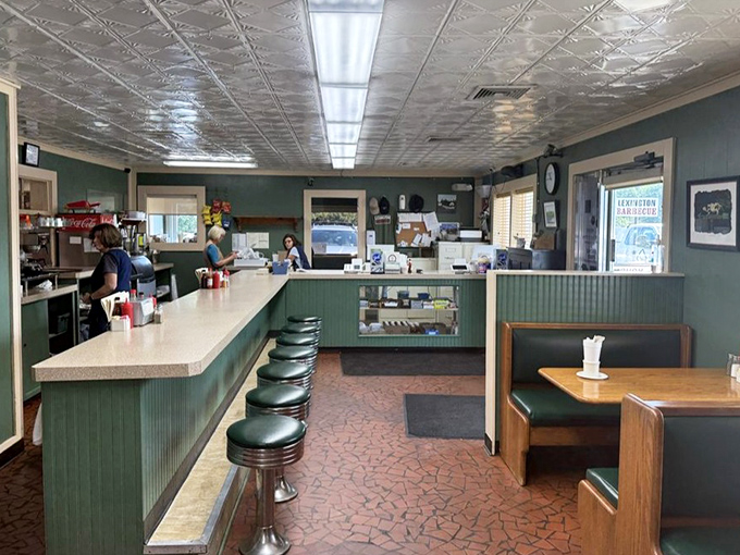 The counter where barbecue dreams come true. Those green stools have supported generations of happy eaters waiting for their smoky reward.