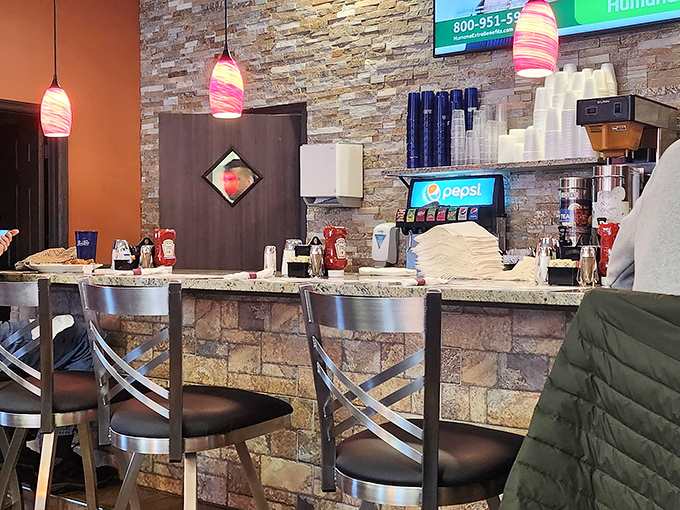 The counter where coffee magic happens. Those pink pendant lights add a splash of whimsy to your caffeine ritual.