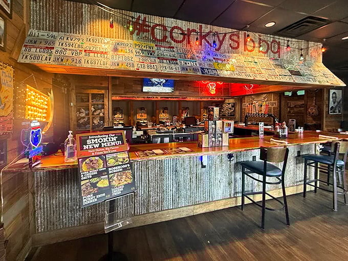The counter where barbecue dreams are born&mdash;corrugated metal, license plates, and the promise of smoky treasures just beyond.
