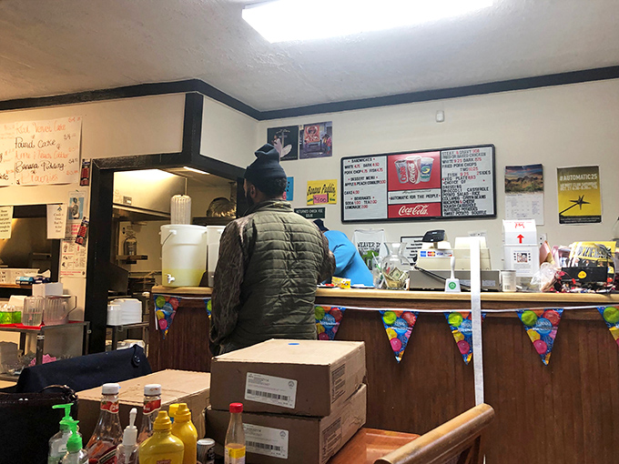 Where the magic happens. That "Questions?" sign with its escalating fees for silly inquiries tells you everything about the place's personality.