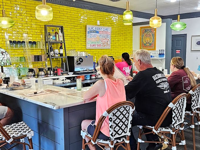 Yellow brick walls and bistro seating create a sunny corner where coffee flows and breakfast dreams come true.