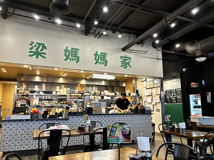 Where the magic happens: skilled hands craft delicious creations behind the counter while hungry patrons eagerly await their turn.