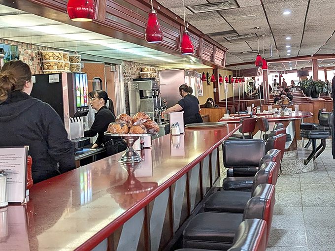 Where the magic happens – the counter seating offers front-row tickets to the short-order ballet. Those pastries aren't just displayed; they're performing.