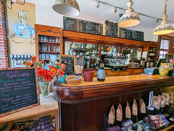 The counter area buzzes with activity, fresh flowers, and the promise of coffee magic happening behind those wooden barriers.