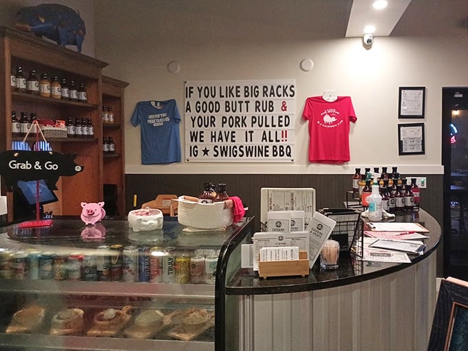 The wall sign says it all – big racks, good butt rubs, and pulled pork. Barbecue humor that makes you smile while your mouth waters.