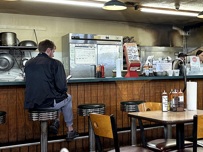 The counter where barbecue dreams come true. One man awaits his destiny while contemplating life's most important question: brisket or ribs?