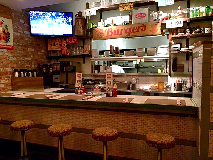 The counter offers front-row seats to culinary theater, where vintage signs and the "Burgers" marquee promise a show worth watching.