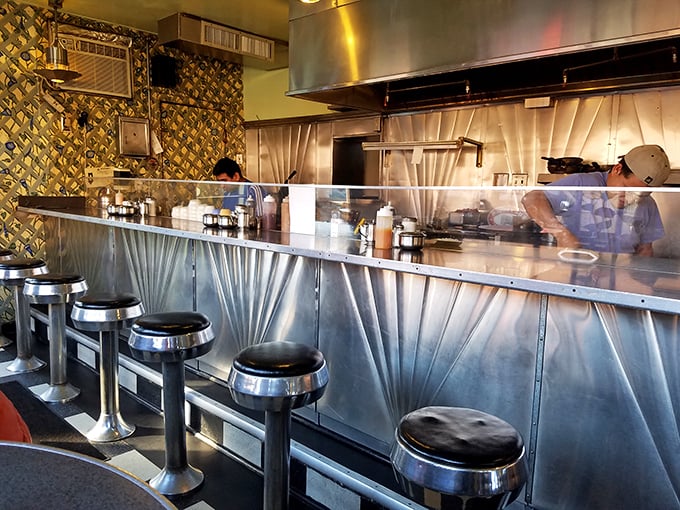 The counter seats aren't just functional&mdash;they're front-row tickets to the breakfast ballet happening behind that gleaming stainless steel.
