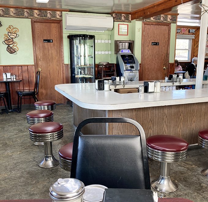 Classic diner counter seating where the stools have witnessed countless first dates, business deals, and "just one more piece of pie" negotiations.