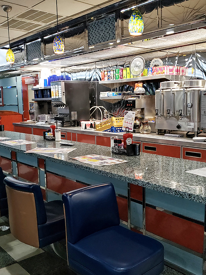 The counter seats—front-row tickets to the greatest show in town, where short-order cooks perform culinary ballet with spatulas as their batons.