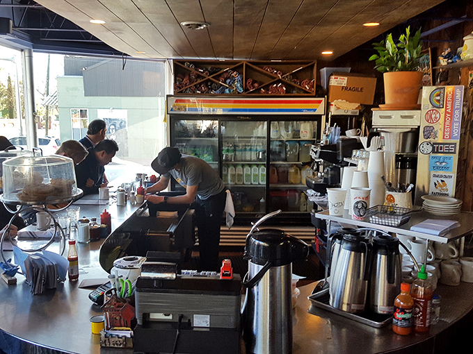 Behind the counter, culinary choreography unfolds—the staff moving with the practiced precision of people who know breakfast is serious business.