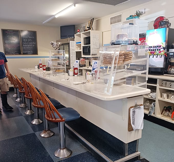 Counter seats offering front-row views of the kitchen action, where solo diners become temporary members of the Maine Diner family.