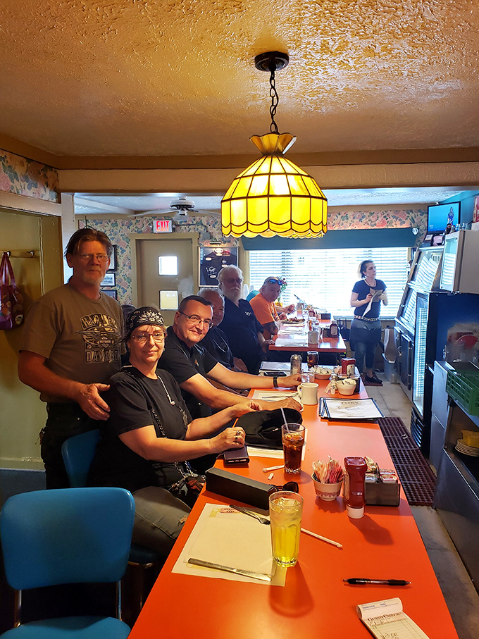Stained glass pendant lamps cast a warm glow over the counter, where regulars gather like a daily reunion of the "Clean Plate Club."