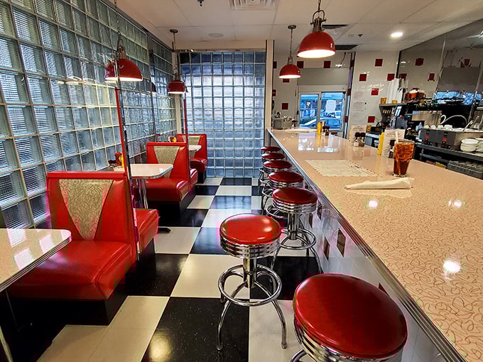 Counter seats offer front-row views to breakfast theater while booths provide cozy corners for lingering over endless coffee.