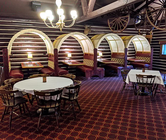 These wagon-wheel booths aren't just seating—they're your personal dining fortress where calories don't count and decisions only involve what to order next.