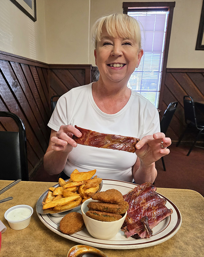 The image shows a diner enjoying their meal with obvious delight&mdash;the universal expression of barbecue happiness.