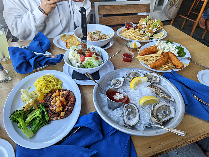 A feast fit for Neptune himself &ndash; fresh oysters, blackened fish, and crispy fries creating the kind of spread that makes everyone at neighboring tables envious.