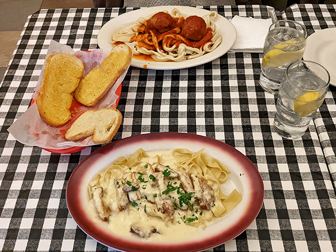A feast fit for royalty: spaghetti with meatballs alongside fettuccine in cream sauce. The bread basket never stood a chance against this dynamic duo.