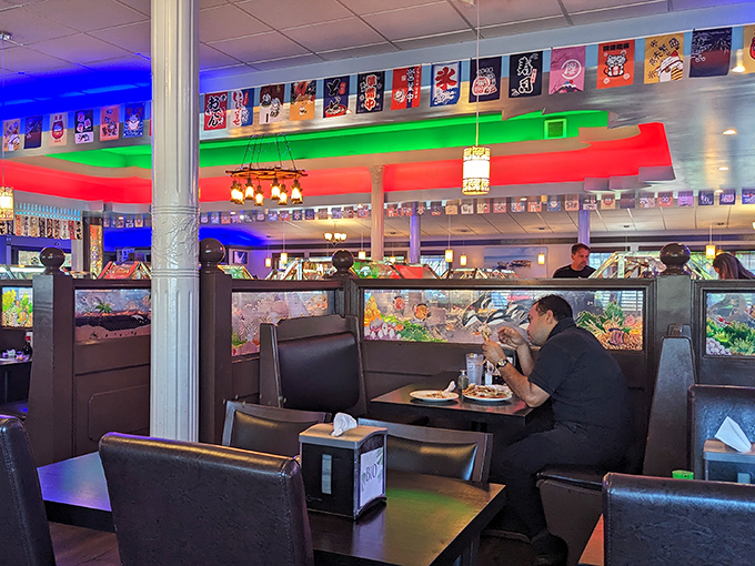Aquariums and colorful lighting create the perfect backdrop for serious eating. This diner knows the buffet golden rule: reconnaissance before commitment.